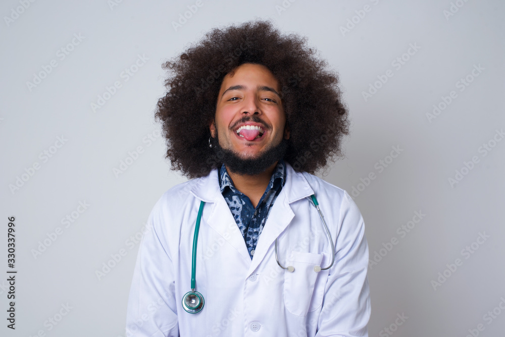 African American doctor man with happy and funny face smiling and ...