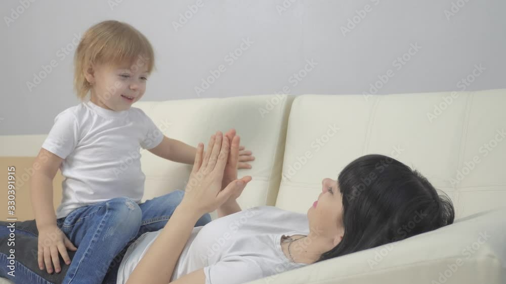 happy family lifestyle concept. mom and daughter clap their hands ...