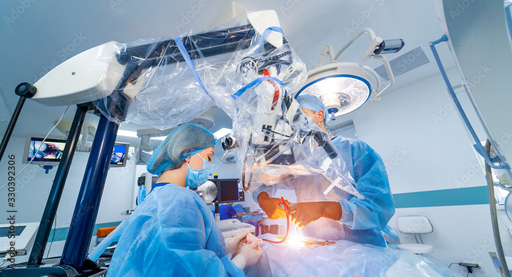 Neurosurgeon is operating with medical robotic surgery machine. Manual ...