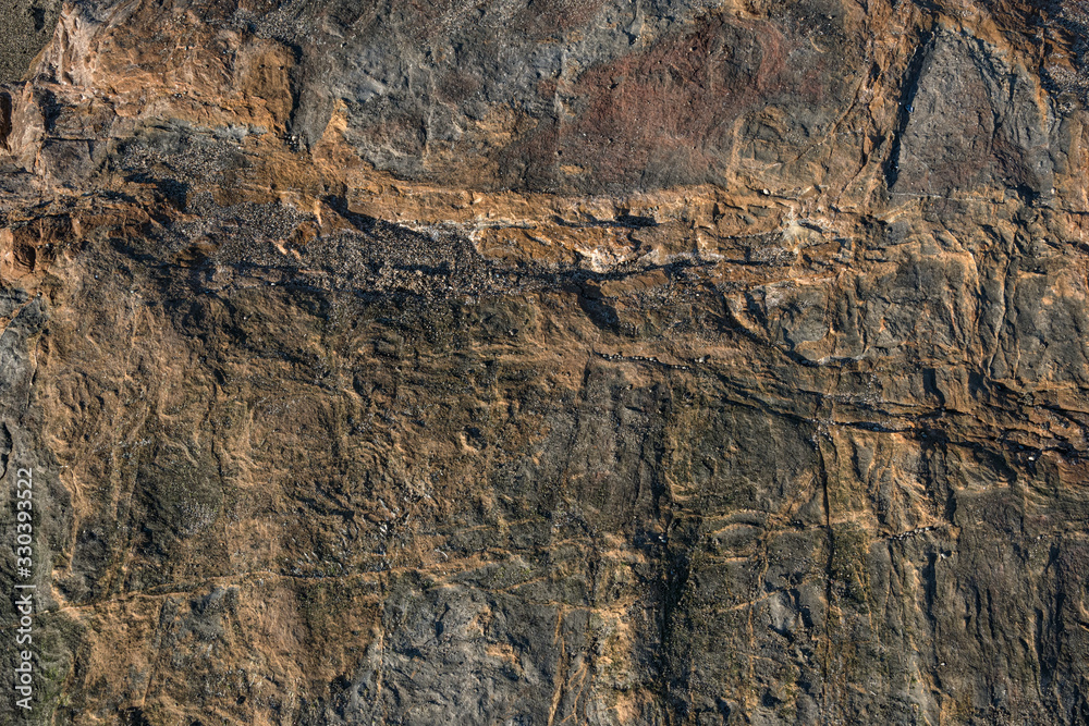 natural surface of brown stone with black and white spots, rock texture ...