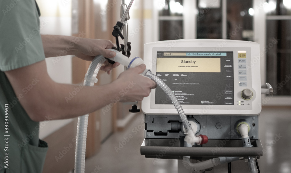 Nurse setting the pulmonary ventilator, medical machine used for patients with respiratory ...