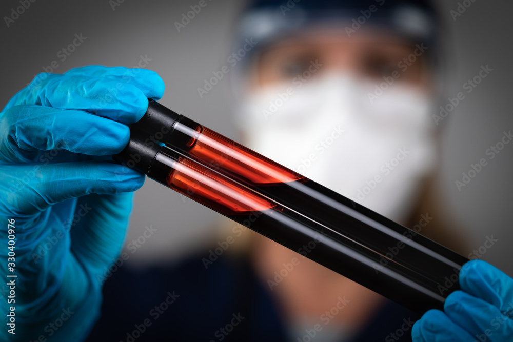 Female Lab Worker Wearing Medical Face Mask Holds Test Tubes of Blood ...