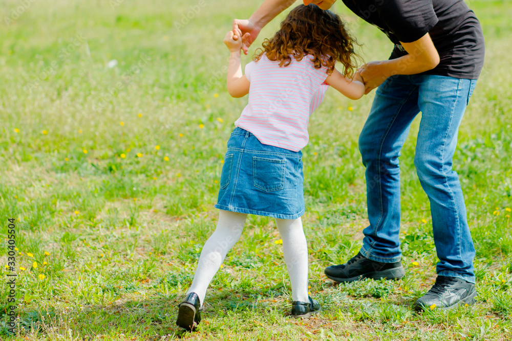 man grabbed girl by arms and pulls. Dad's playing with daughter. Father ...