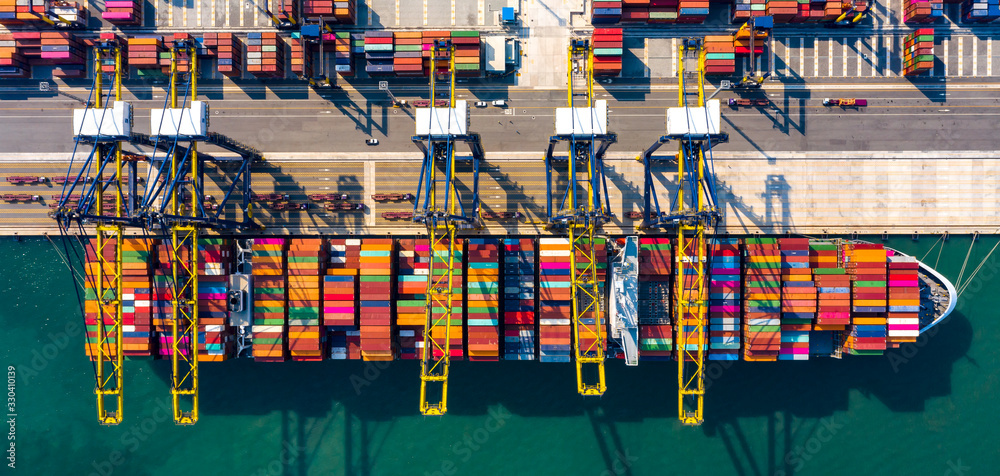 Foto de Aerial top view over international cargo ship at industrial ...