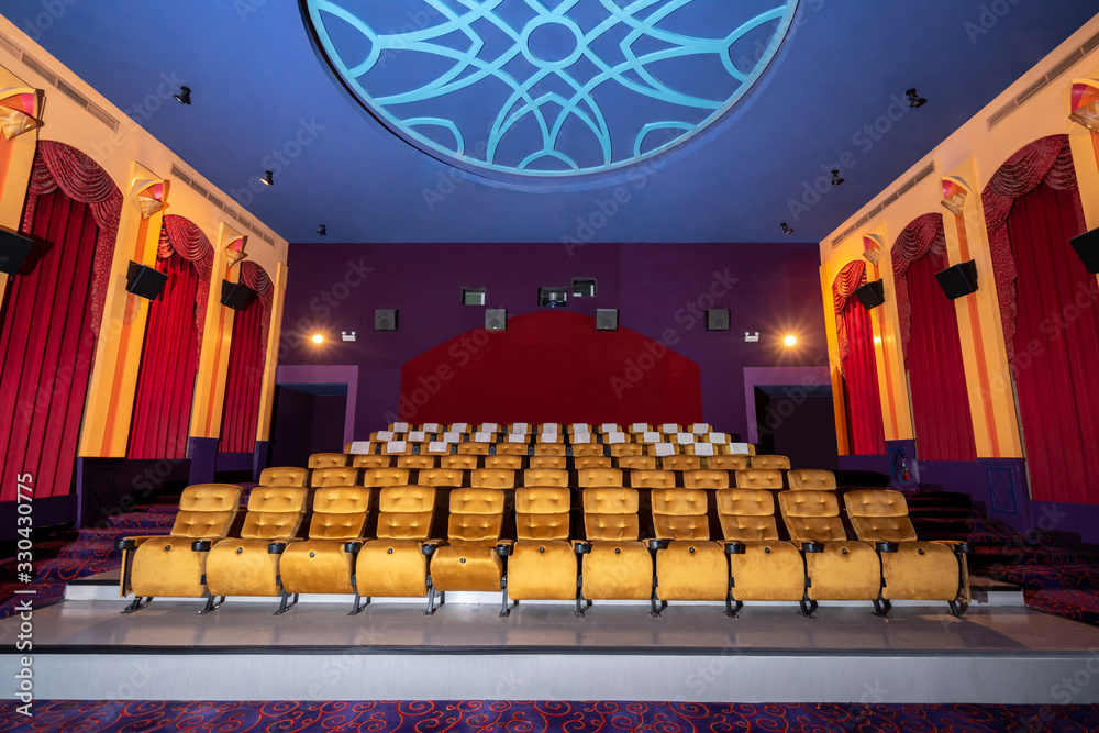 Large cinema theater interior with seat rows for audience to sit in ...
