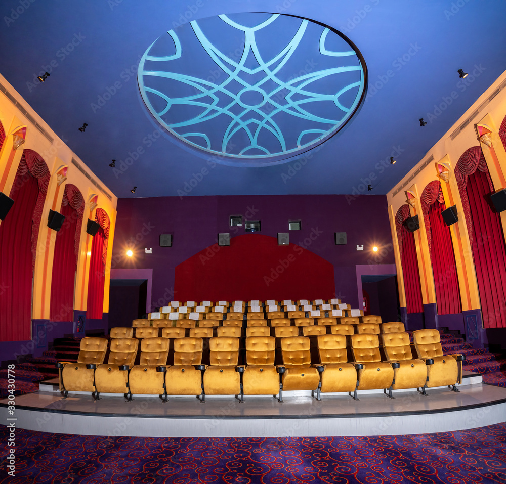Large cinema theater interior with seat rows for audience to sit in ...