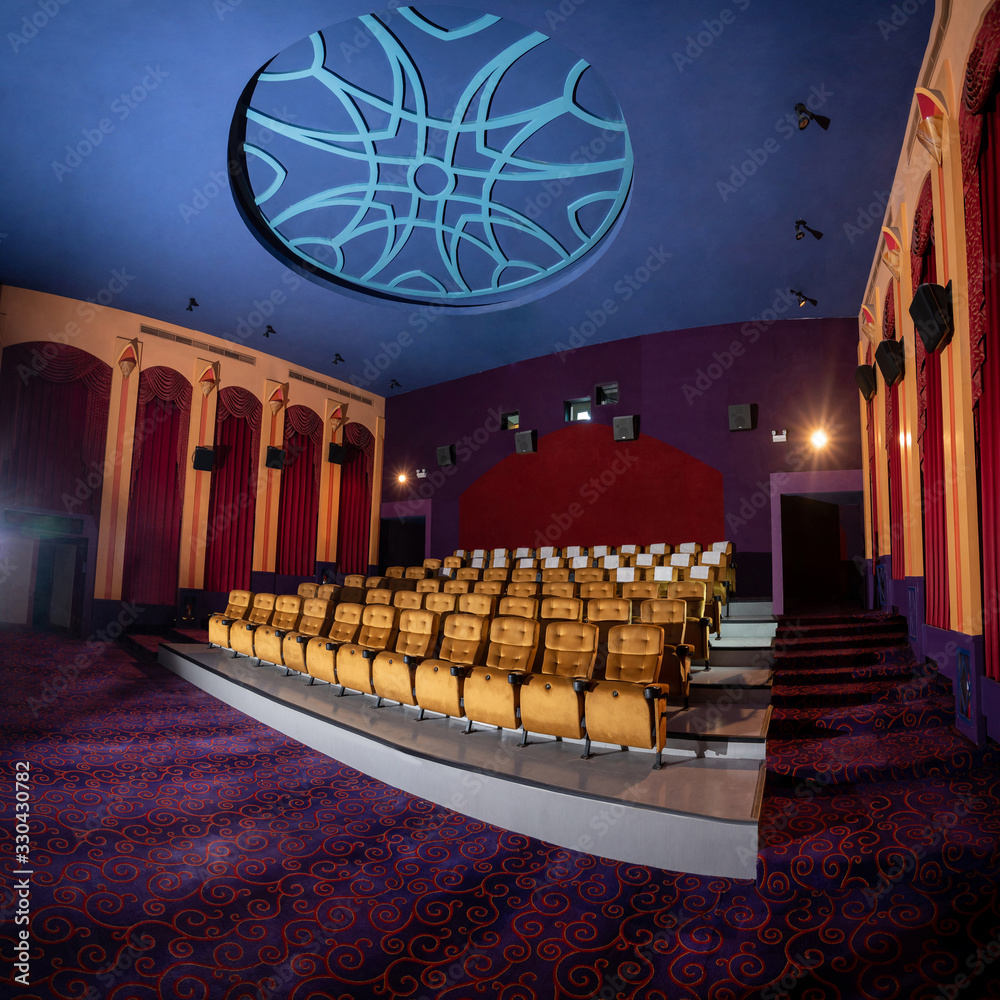 Large cinema theater interior with seat rows for audience to sit in ...