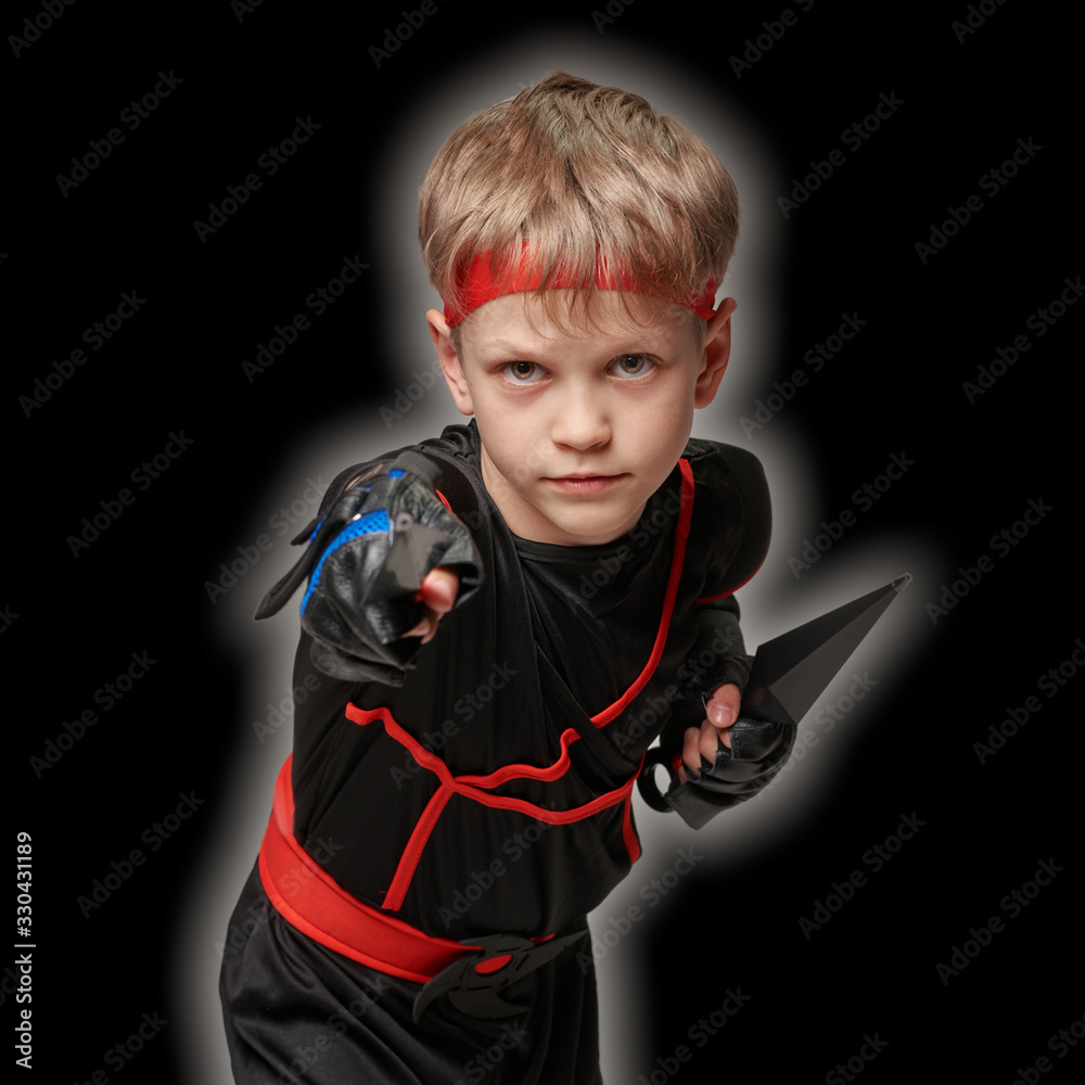 Ninja boy ready to throw kunai for attack on black background Stock ...