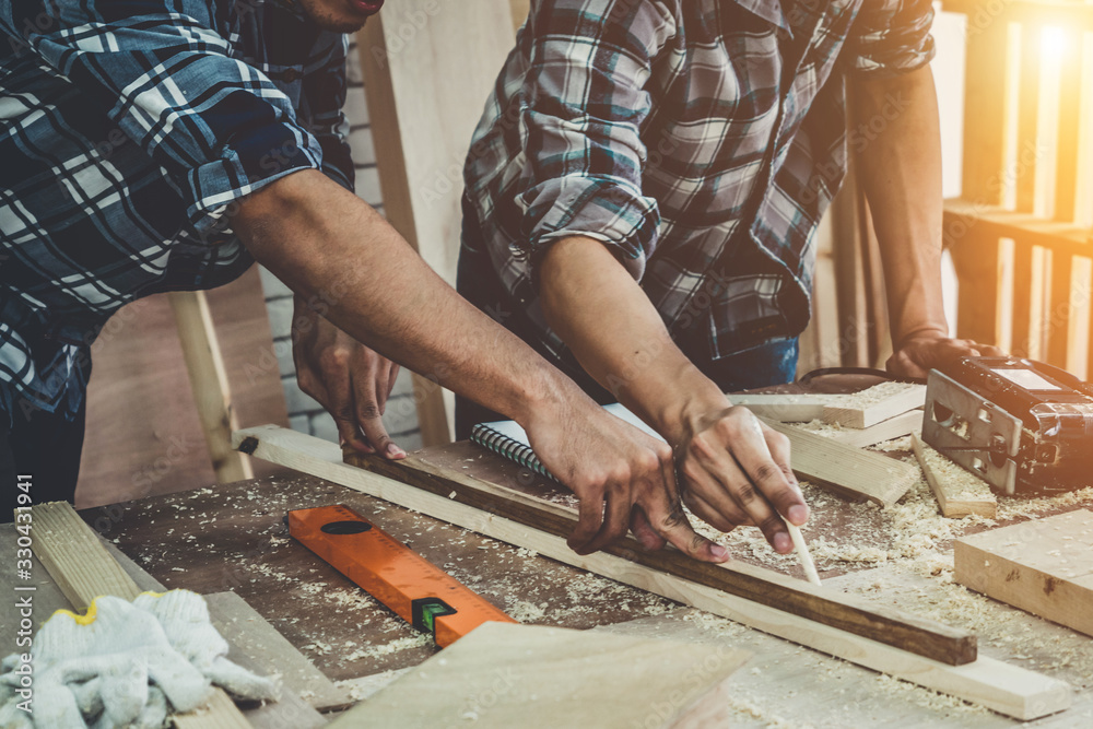 Carpenter working on wood craft at workshop to produce construction ...