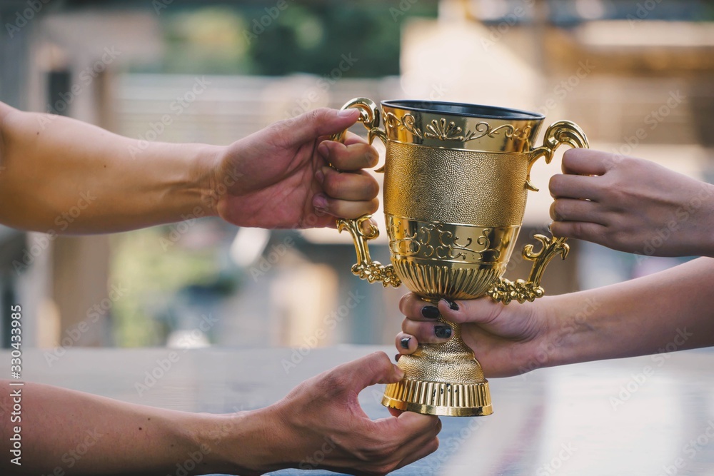 Hands scramble for the golden trophy cup. . Sport, Business, Winning ...