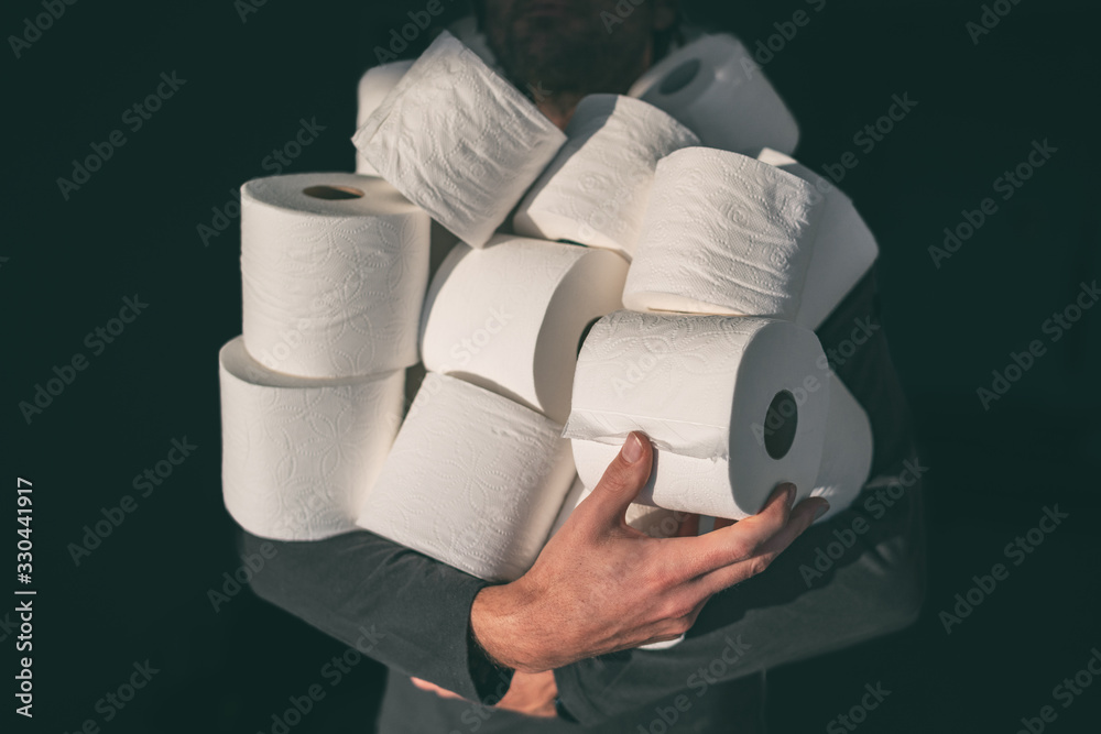 Toilet paper shortage coronavirus panic buying man hoarding carrying many rolls at home in fear ...