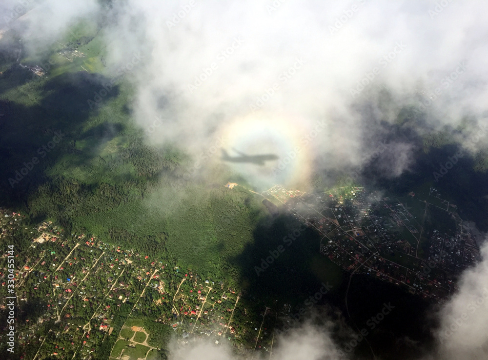 Glory around the shadow of a plane. Pilot’s halo or glory of the pilot ...
