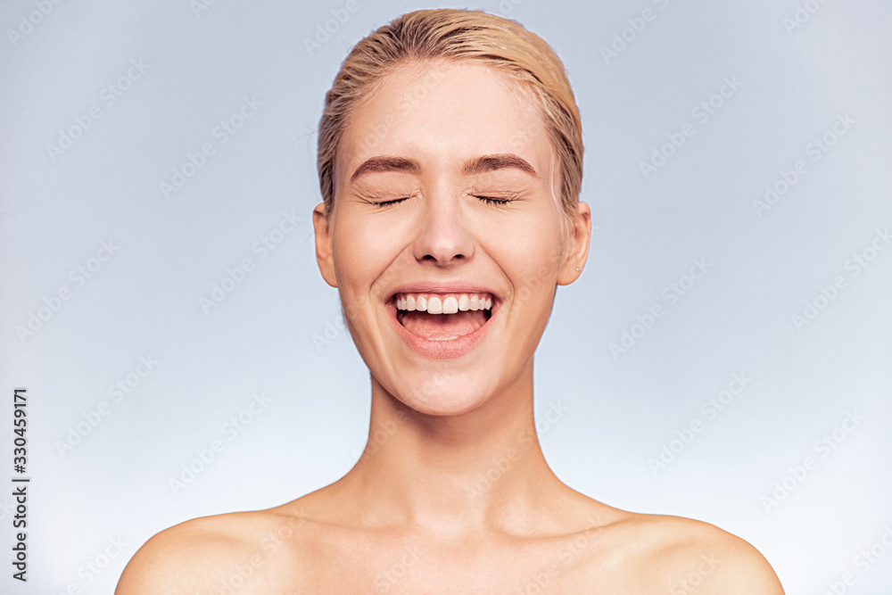 Frontal portrait of a girl with closed eyes and open mouth. Face close ...