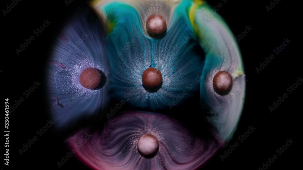 abstract reaction of dissolving colorful candies in a liquid, petri ...
