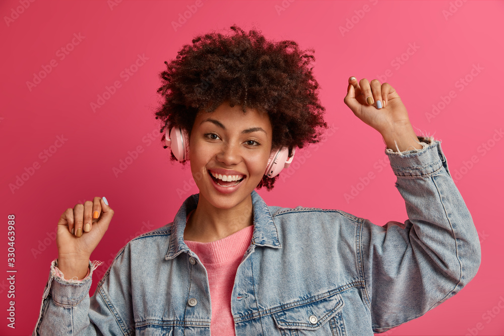 Joyful teenage girl meloman dances and enjoys every bit of favorite ...