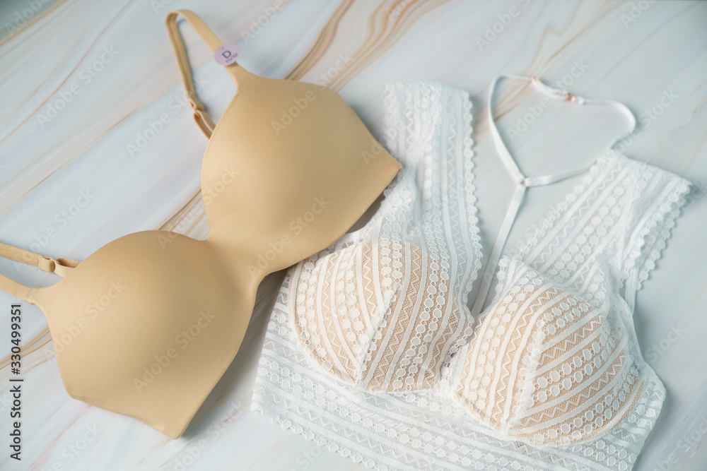 Different color bras on white marble background. Stock Photo | Adobe Stock