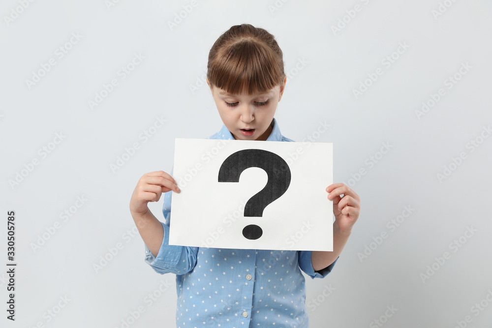 Emotional girl holding sheet of paper with question mark on white ...
