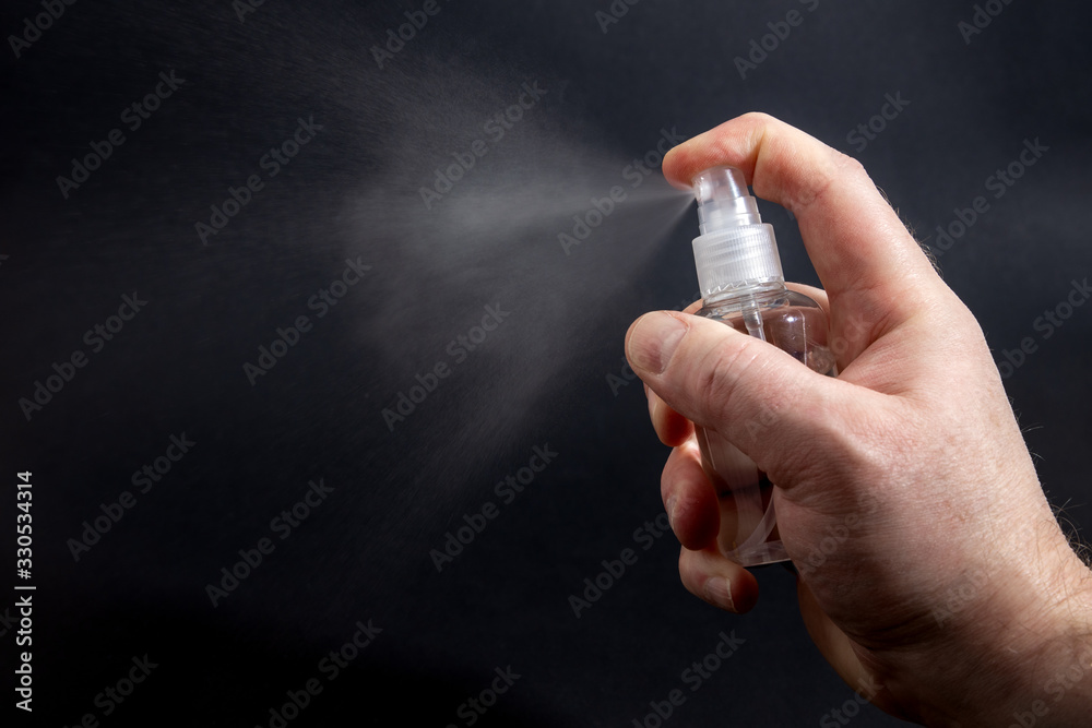 Alcohol spray from a bottle to desinfect surfaces and items. Stock ...