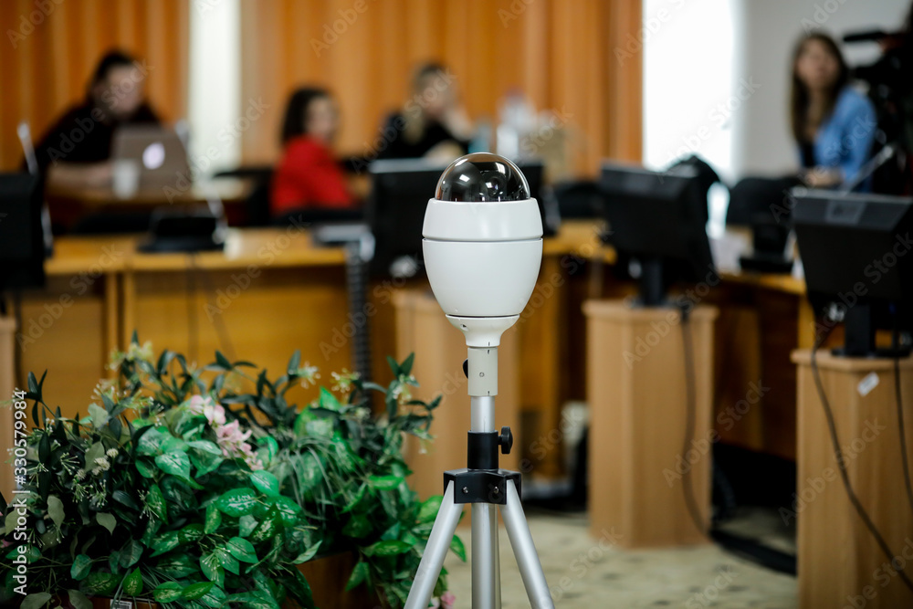 Details with a video camera in the middle of a meeting room. Video ...