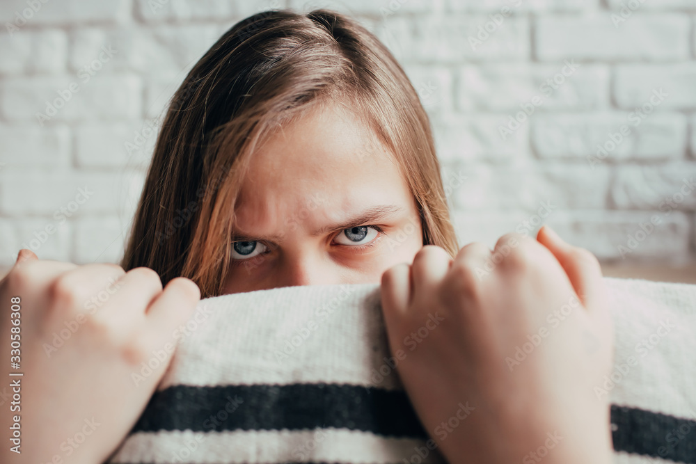 depressed girl with blue eyes and long .light brown hair hides to a ...