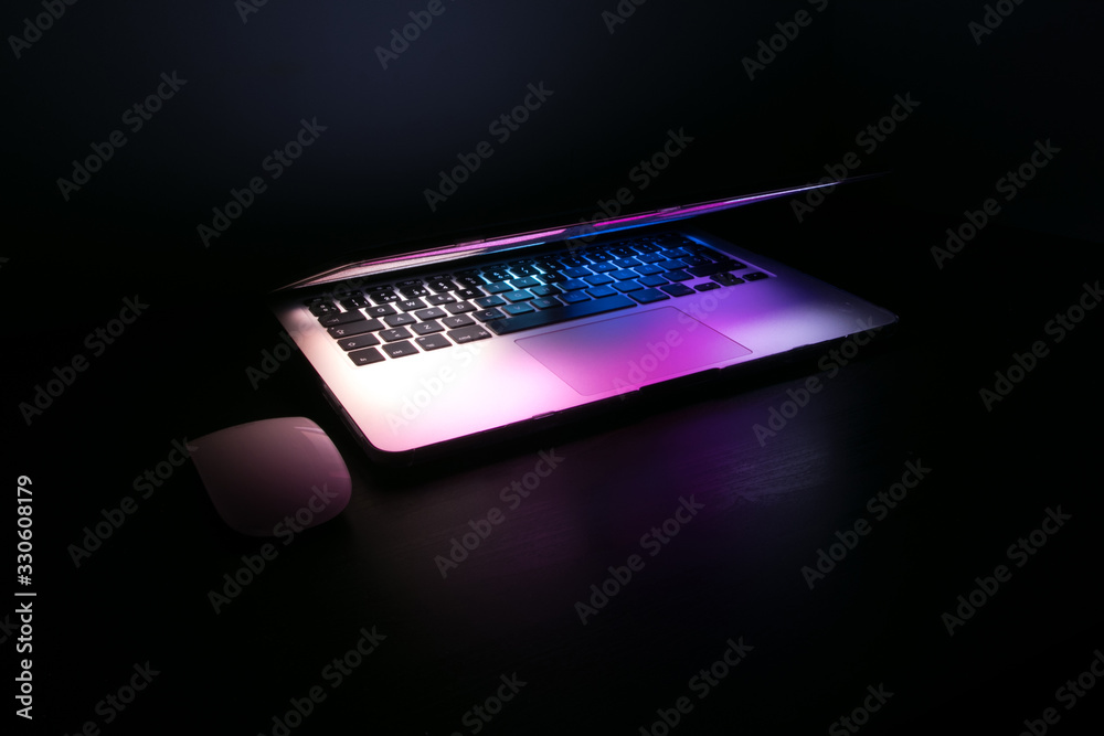 Dark Room illuminated by a computer screen at night, no people. Empty ...