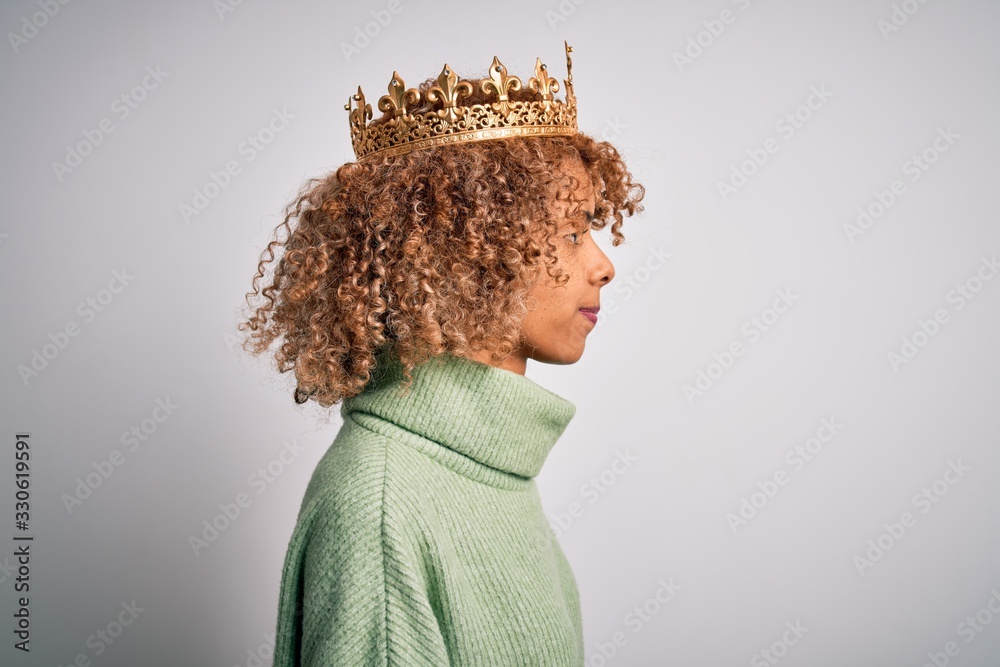 Young african american woman wearing golden crown of queen over ...