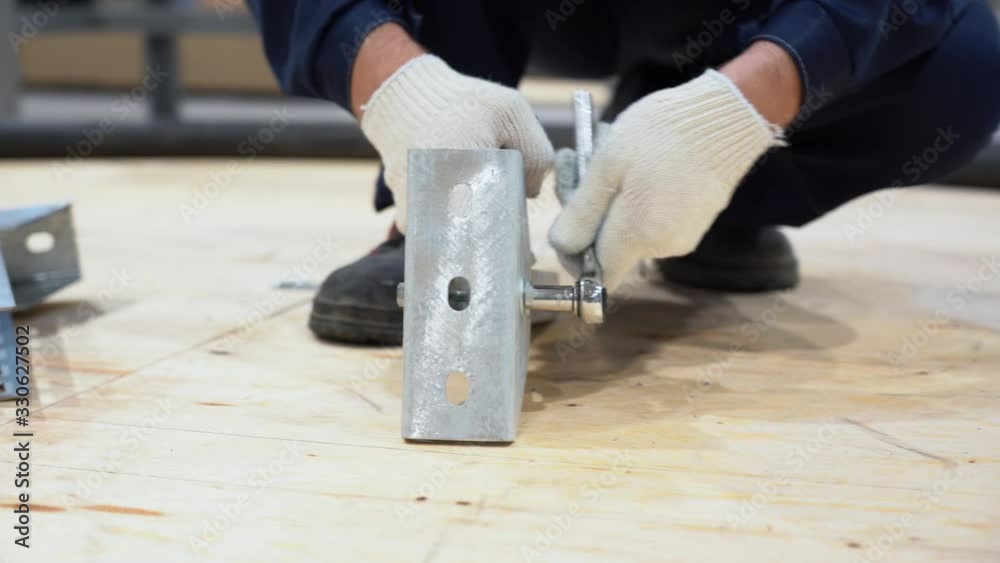 Worker man squatting, wear blue suit, white gloves close up view ...