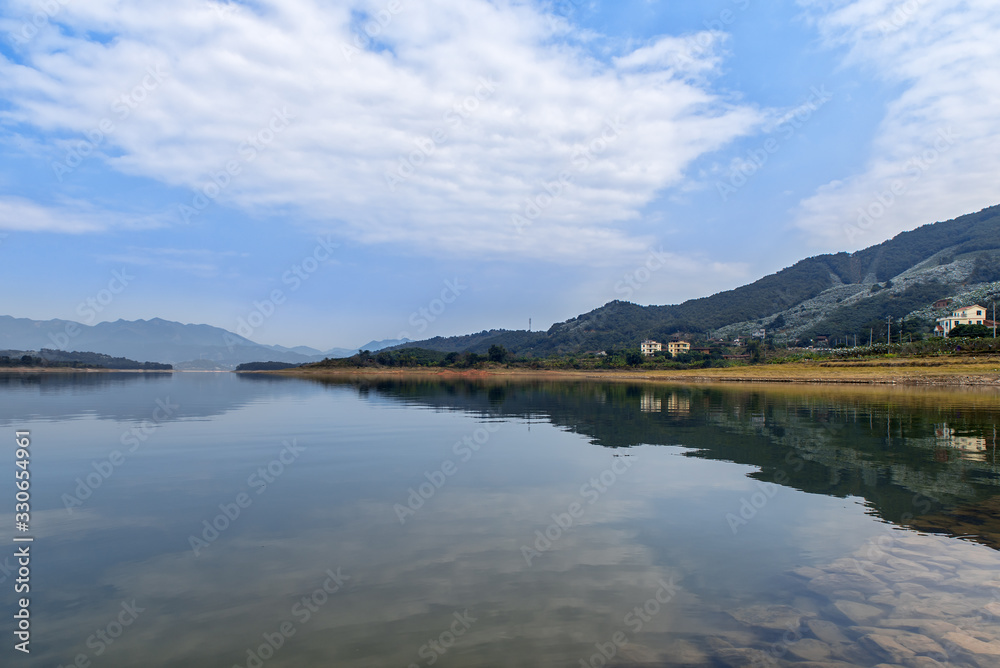 The reservoir under blue sky and white clouds and its ecological ...