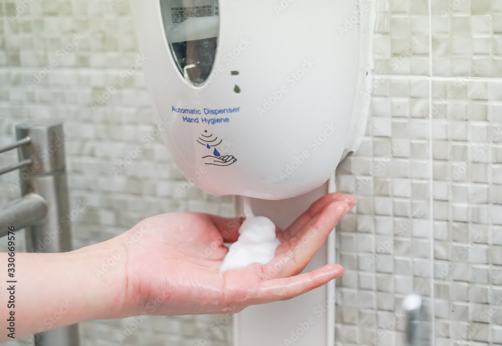 close up woman hand using automatic dispenser hand sanitizer for hands ...