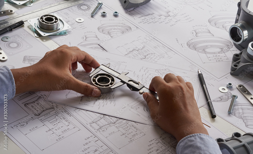 Engineer technician designing drawings mechanical parts engineering ...