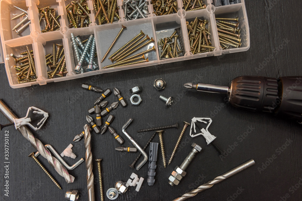 set of tools on the table, a screwdriver with a set of drill bits and ...