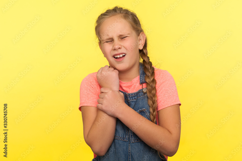 Child with injured hand. Portrait of upset little girl in denim ...