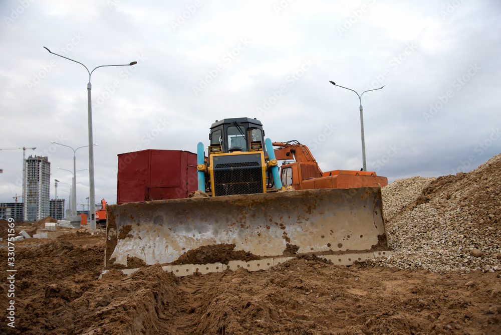 Bulldozer during land clearing and foundation digging at large ...