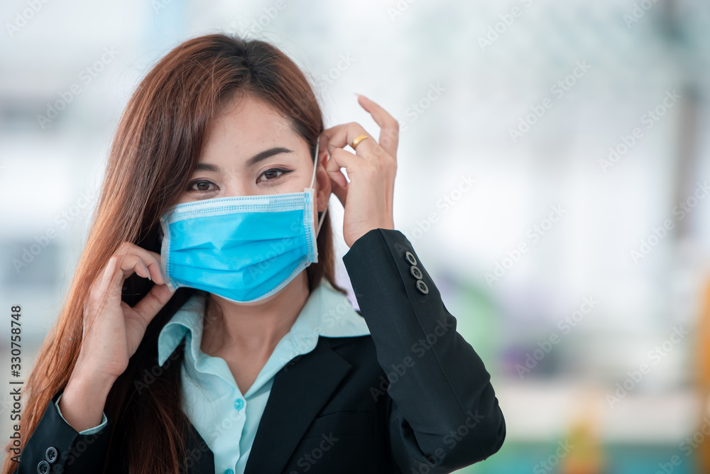 Beautiful business woman wearing a mask after the covid-19 virus spread ...