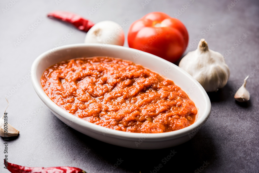 onion tomato masala or puree for indian gravy, served in a bowl with ...