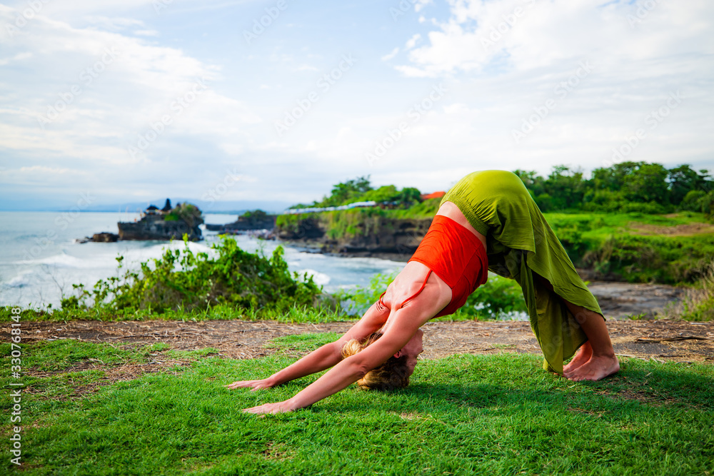Outdoor yoga practice. Young woman practicing Parvatasana, Mountain ...