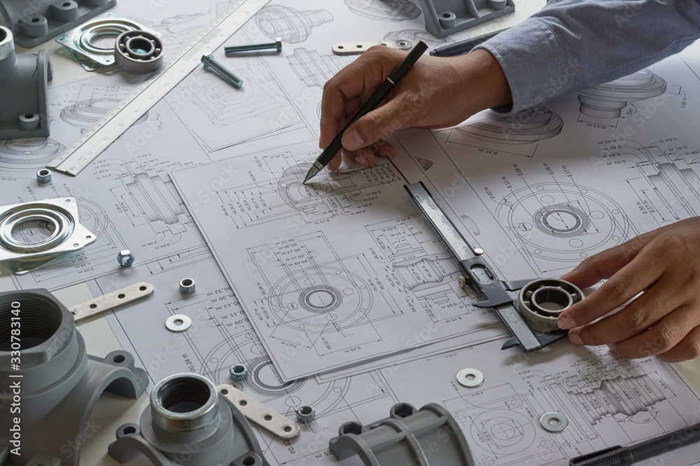 Engineer technician designing drawings mechanical parts engineering ...