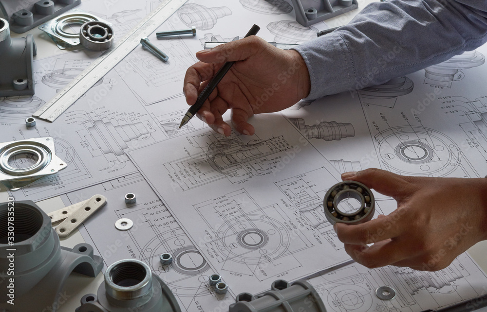 Engineer technician designing drawings mechanical parts engineering ...