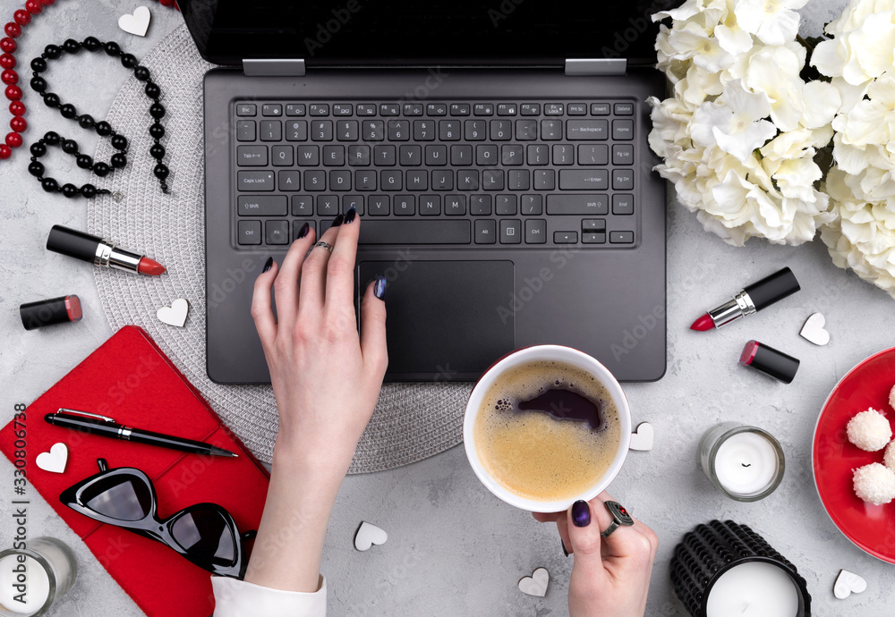 Beautiful groomed woman's hands typing at keyboard on the home office ...