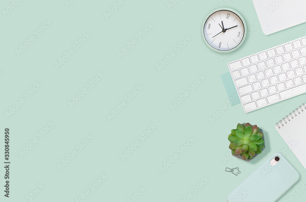 Flat layout of workplace. Succulent, keyboard and empty notepad on mint ...