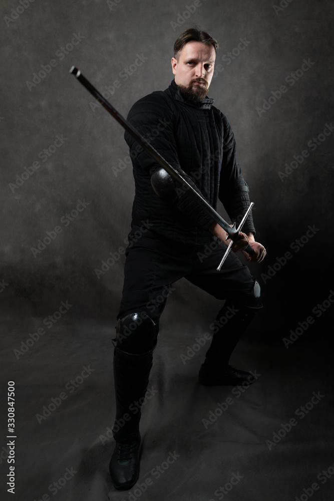 A man in a scary mask with a beard with a skid swords. Historical ...