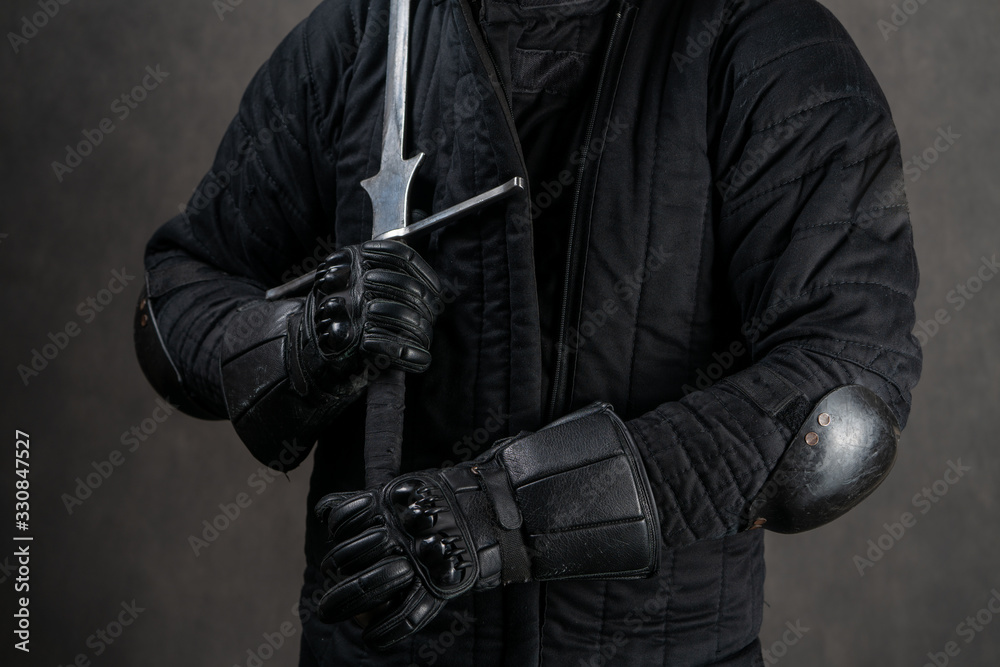 Two-handed sword in the hands of a man detail. Historical European ...