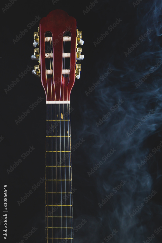 Acoustic guitar in smoke on the black background. musical instrument ...