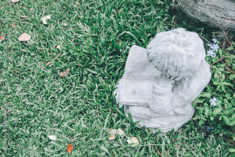 Backyard Statue Decorations on a sunny day the boy statue is sitting ...