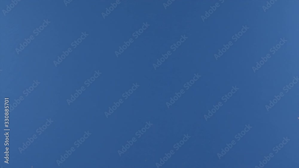 A toilet paper roll is seen flying in front of a blue screen. Stock ...