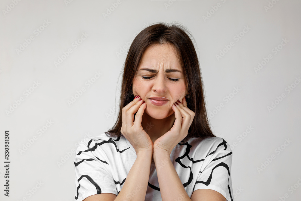 young sad woman suffering from tooth pain, caries. girl having ...