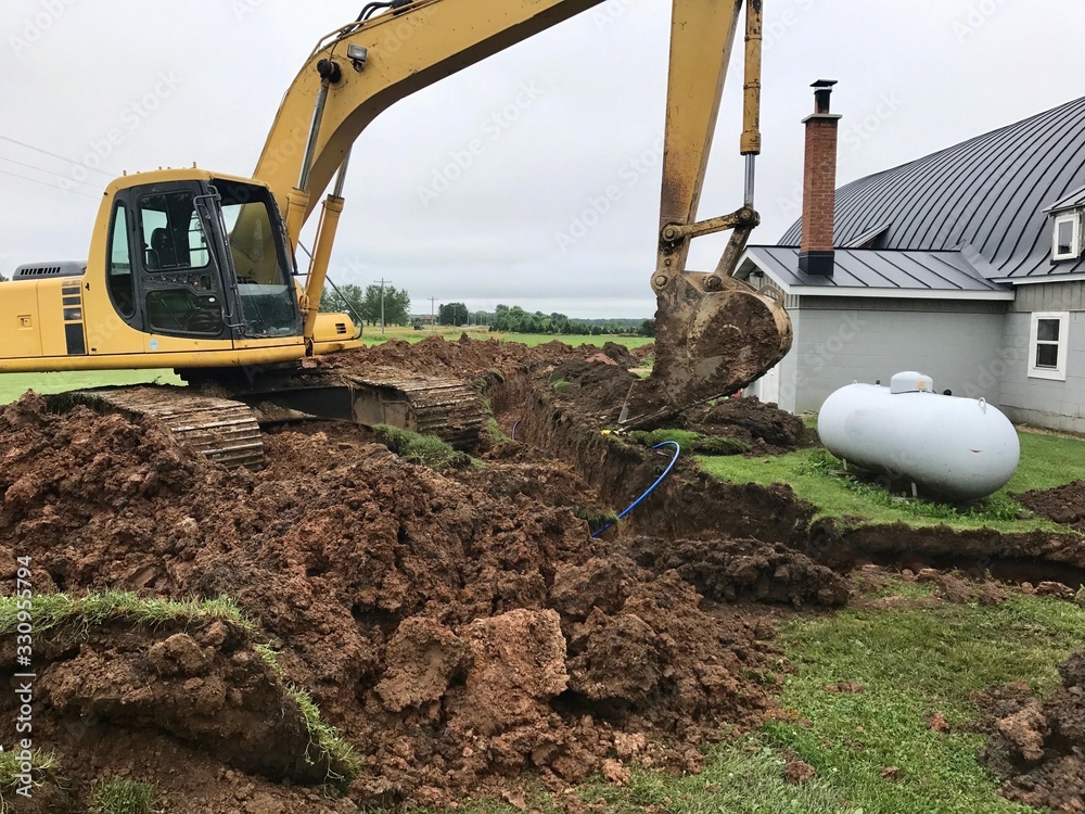 Excavator digging a trench Stock Photo | Adobe Stock