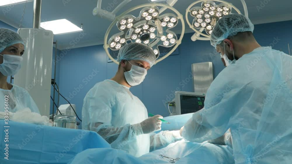 An international team of doctors performs a complex surgical operation ...