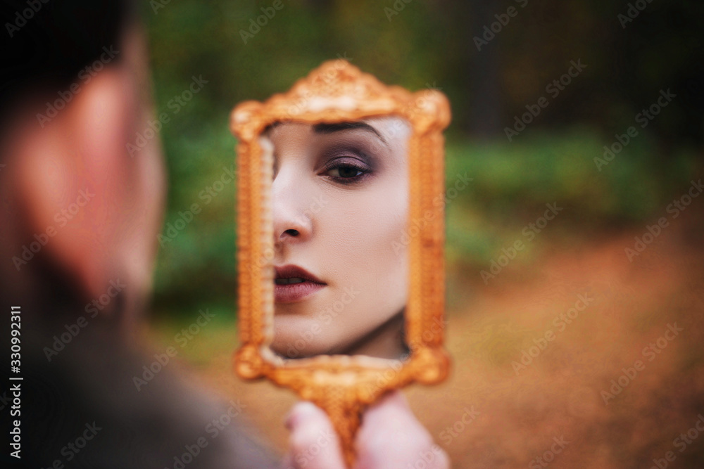 The queen is holding a mirror. Evil sorceress in the forest. Slavic ...