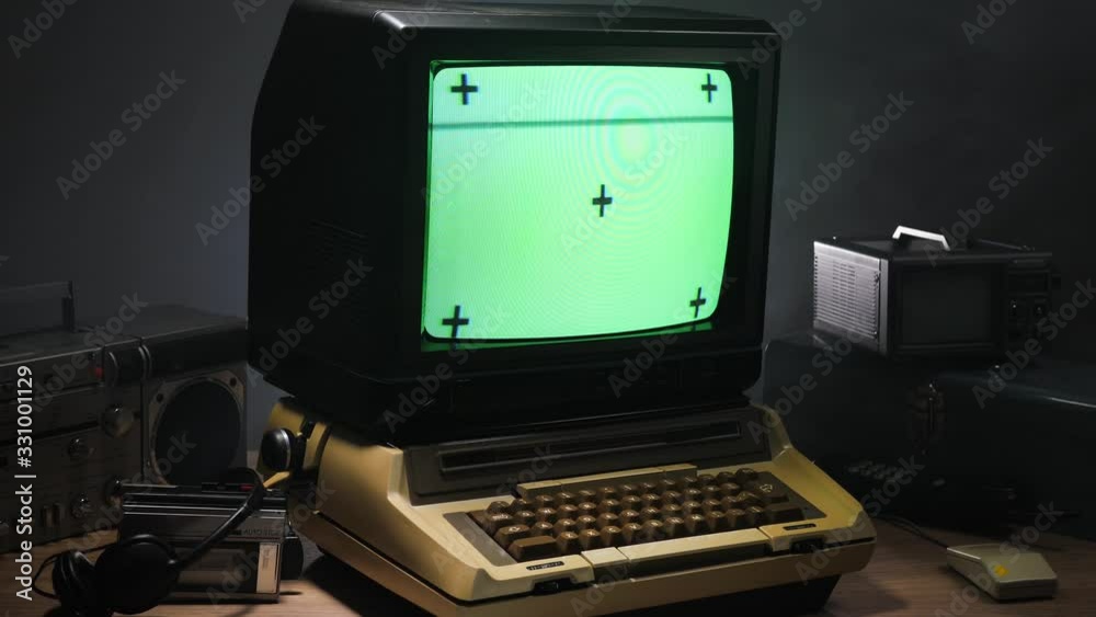 Zooming out of green screen on an old vintage style computer monitor ...